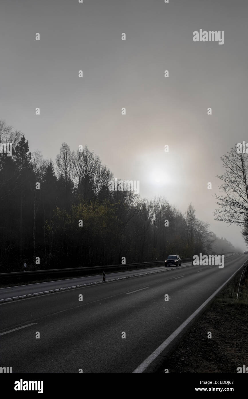 Germany, Eifel, car driving on Federal road in the fog Stock Photo - Alamy