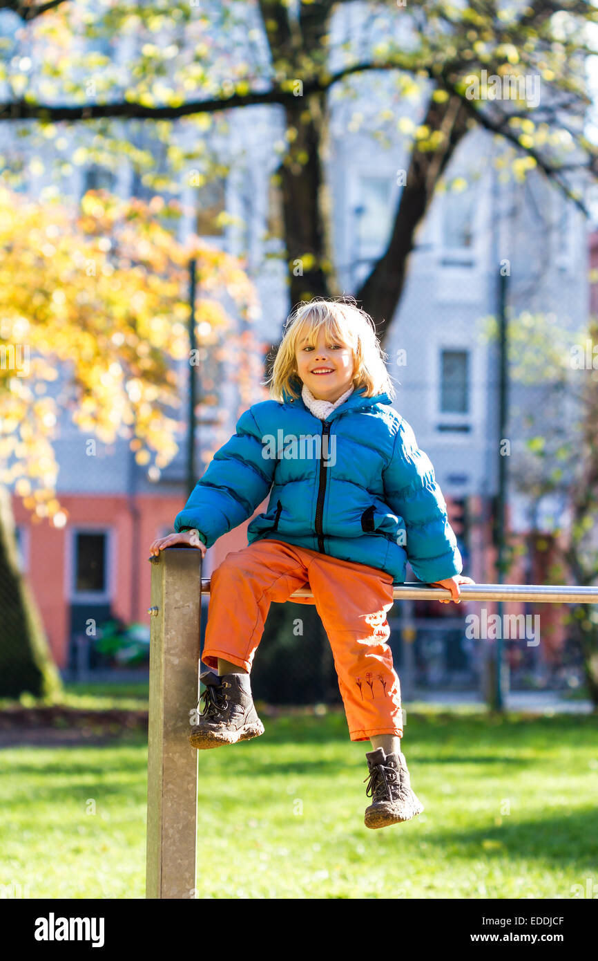 Little girl sitting at high bar Stock Photo - Alamy