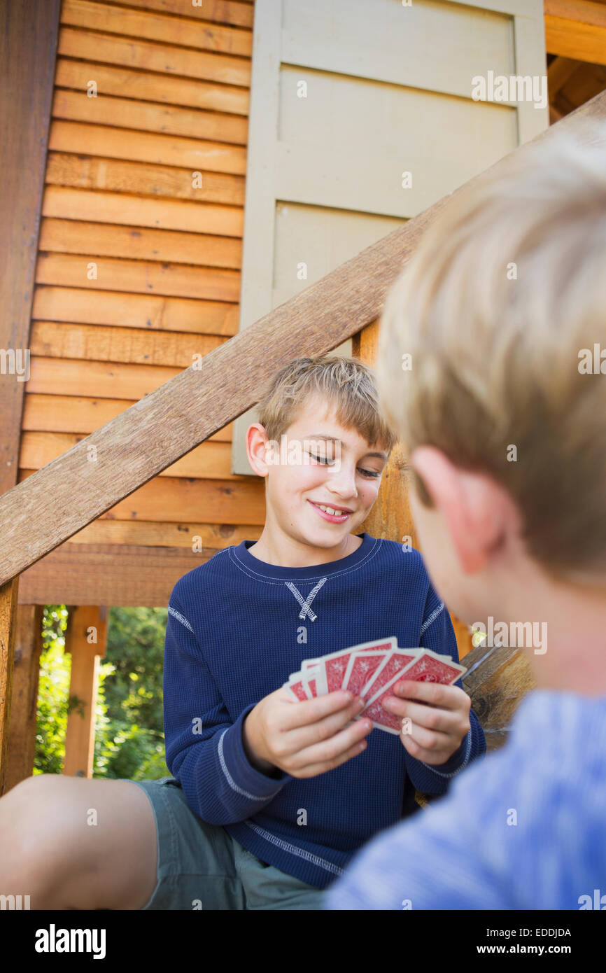 Two brothers playing cards Stock Photo - Alamy