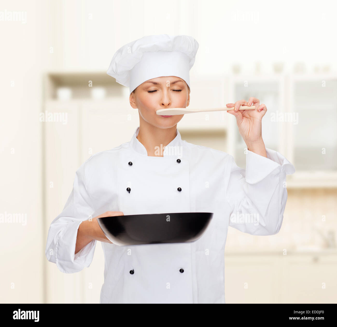 smiling female chef with pan and spoon Stock Photo - Alamy