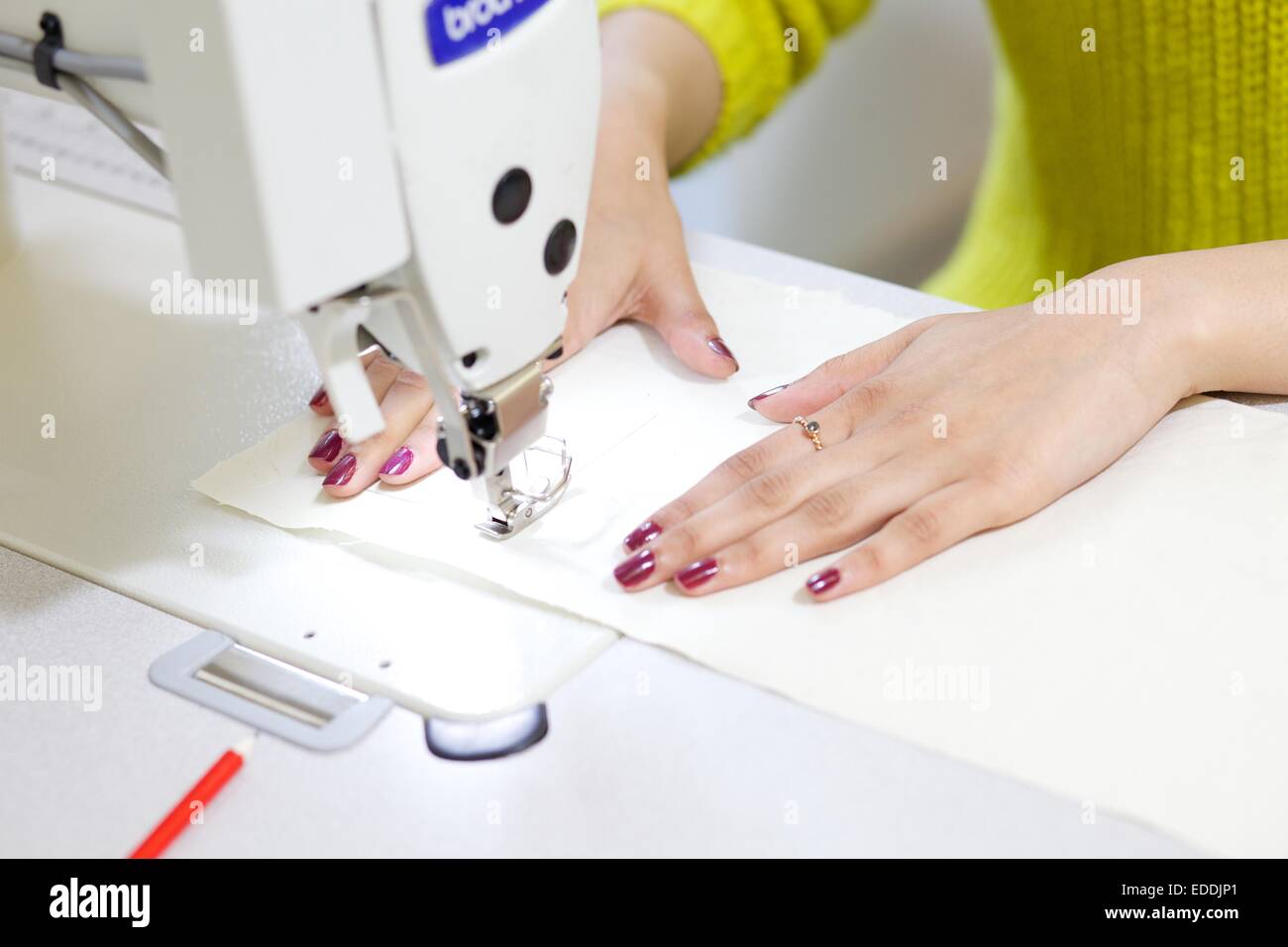 shot of hands using sewing machine Stock Photo - Alamy