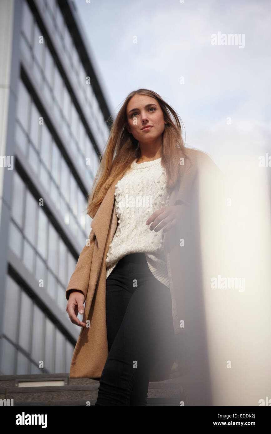 Portrait of long-haired young woman leaning on railing Stock Photo - Alamy