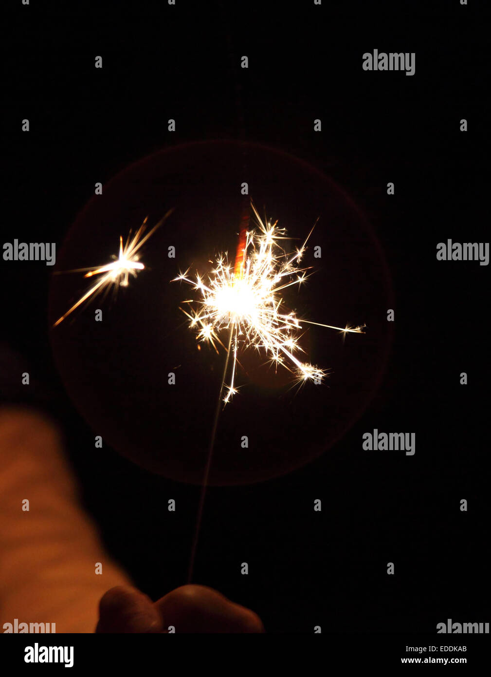 burning sparkler on a dark background Stock Photo - Alamy