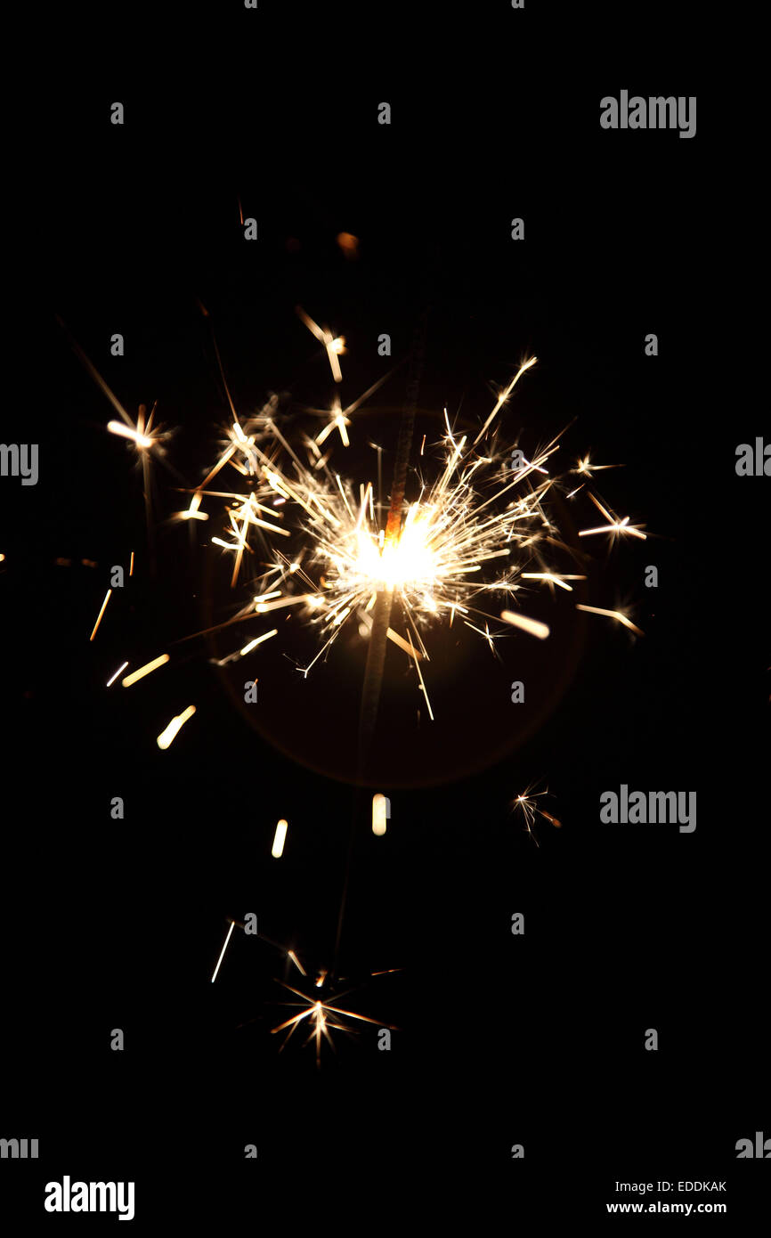 burning sparkler on a dark background Stock Photo - Alamy