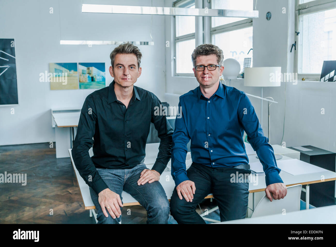 Two designers sitting in their studio Stock Photo - Alamy