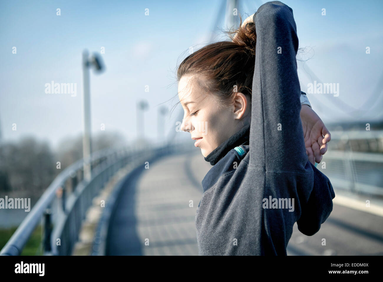 Young woman doing stretching exercise after jogging Stock Photo - Alamy
