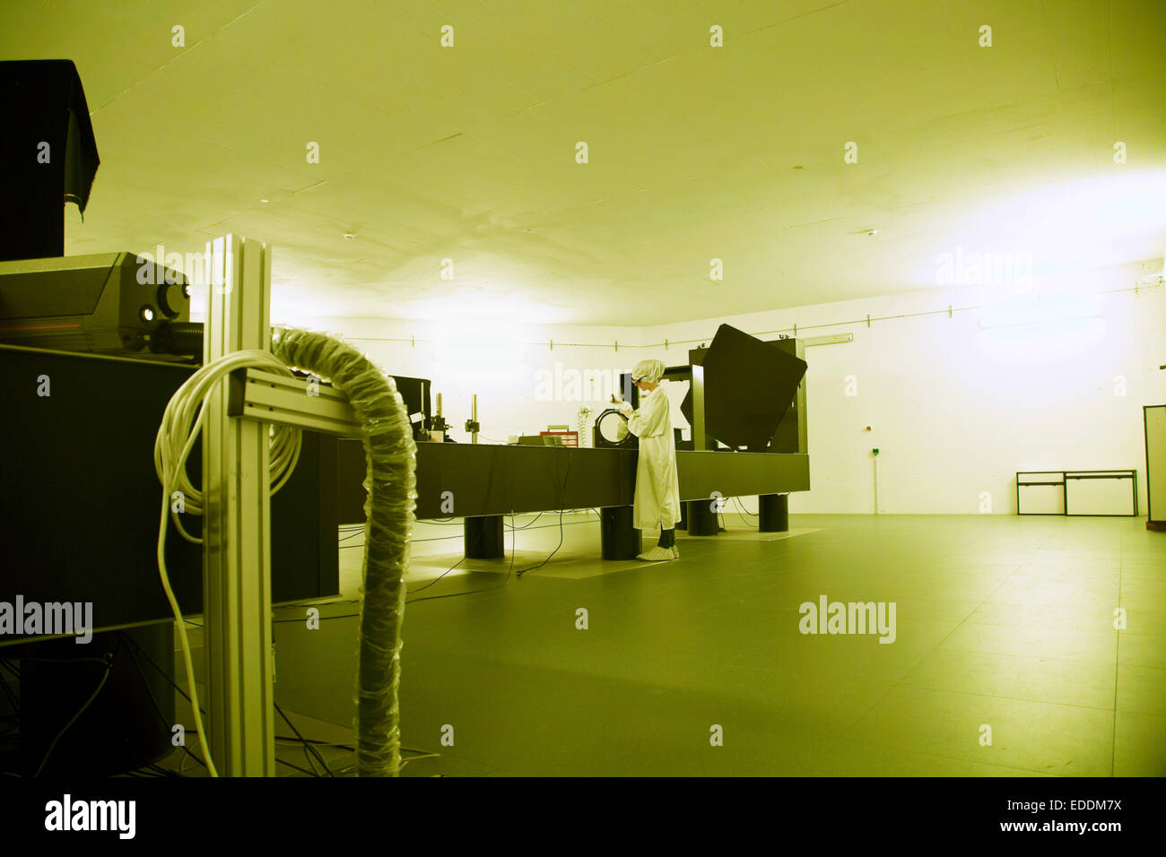 Germany, Female technician working in optical clean room unit Stock ...