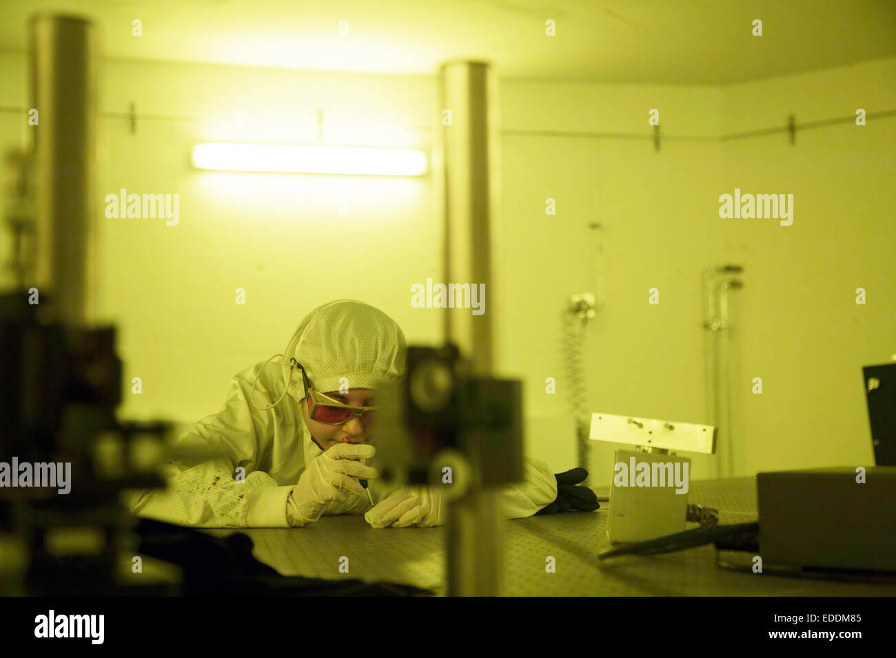 Germany, Female technician working in optical clean room unit Stock ...