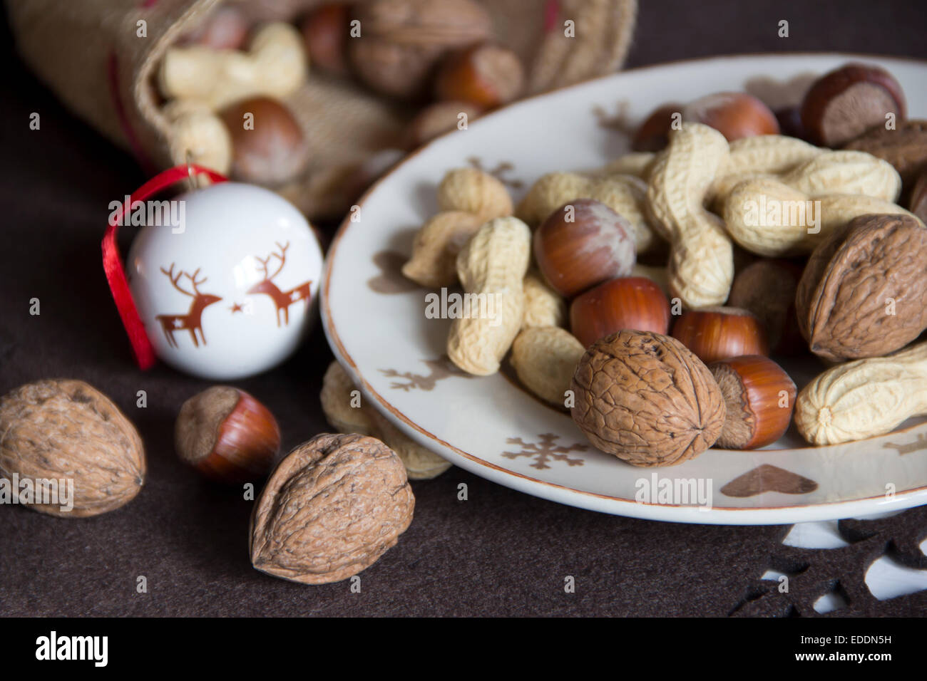 Dish of different nuts an d Christmas decoration Stock Photo - Alamy