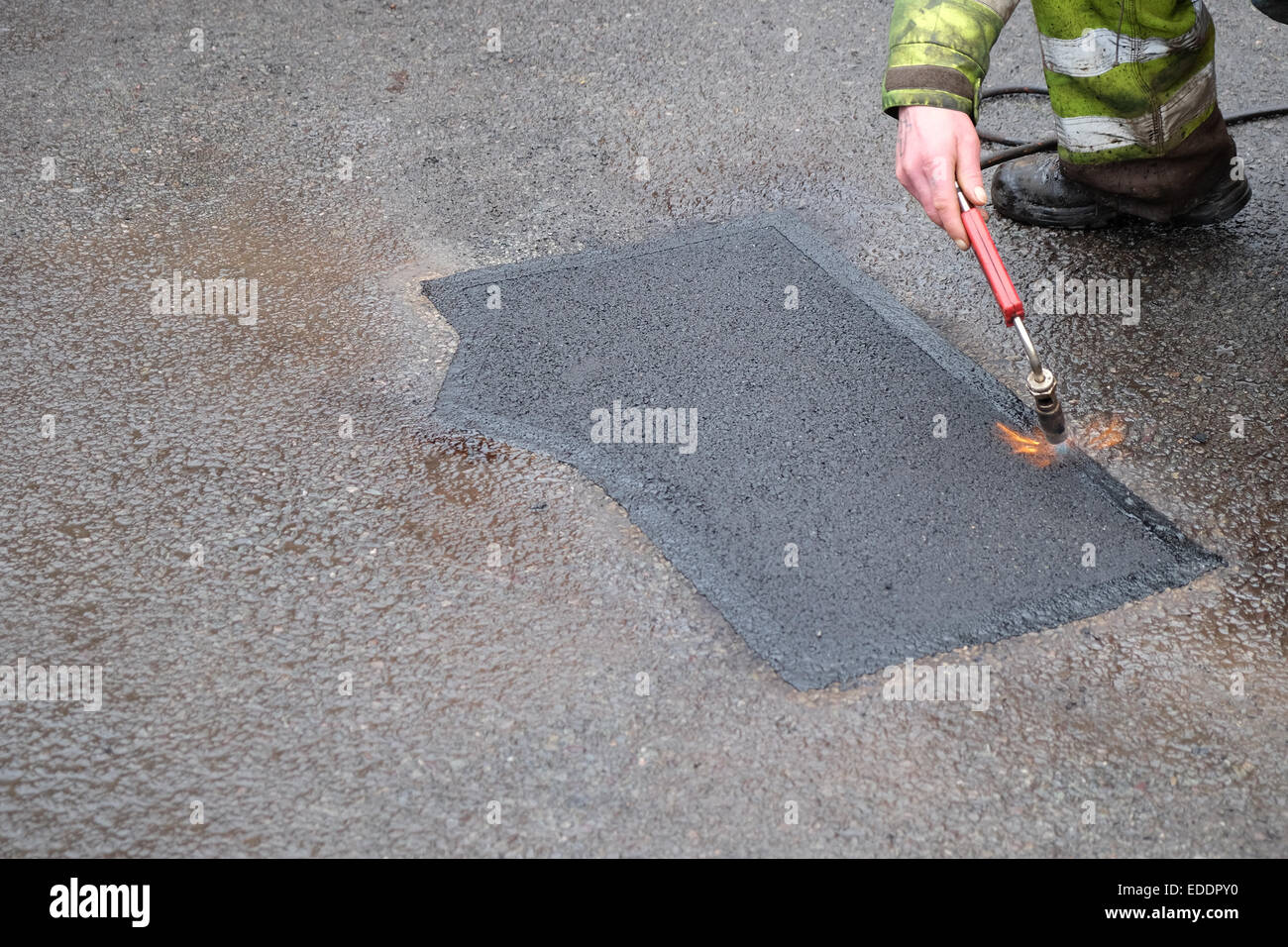 Workmen repair potholes in farley way Stock Photo - Alamy