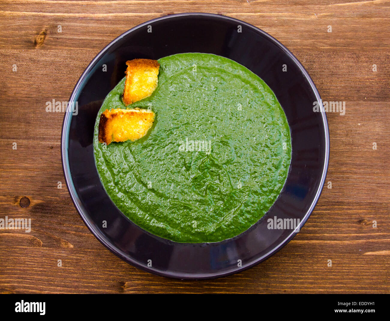 Creamed spinach with toasted wooden table top view Stock Photo - Alamy