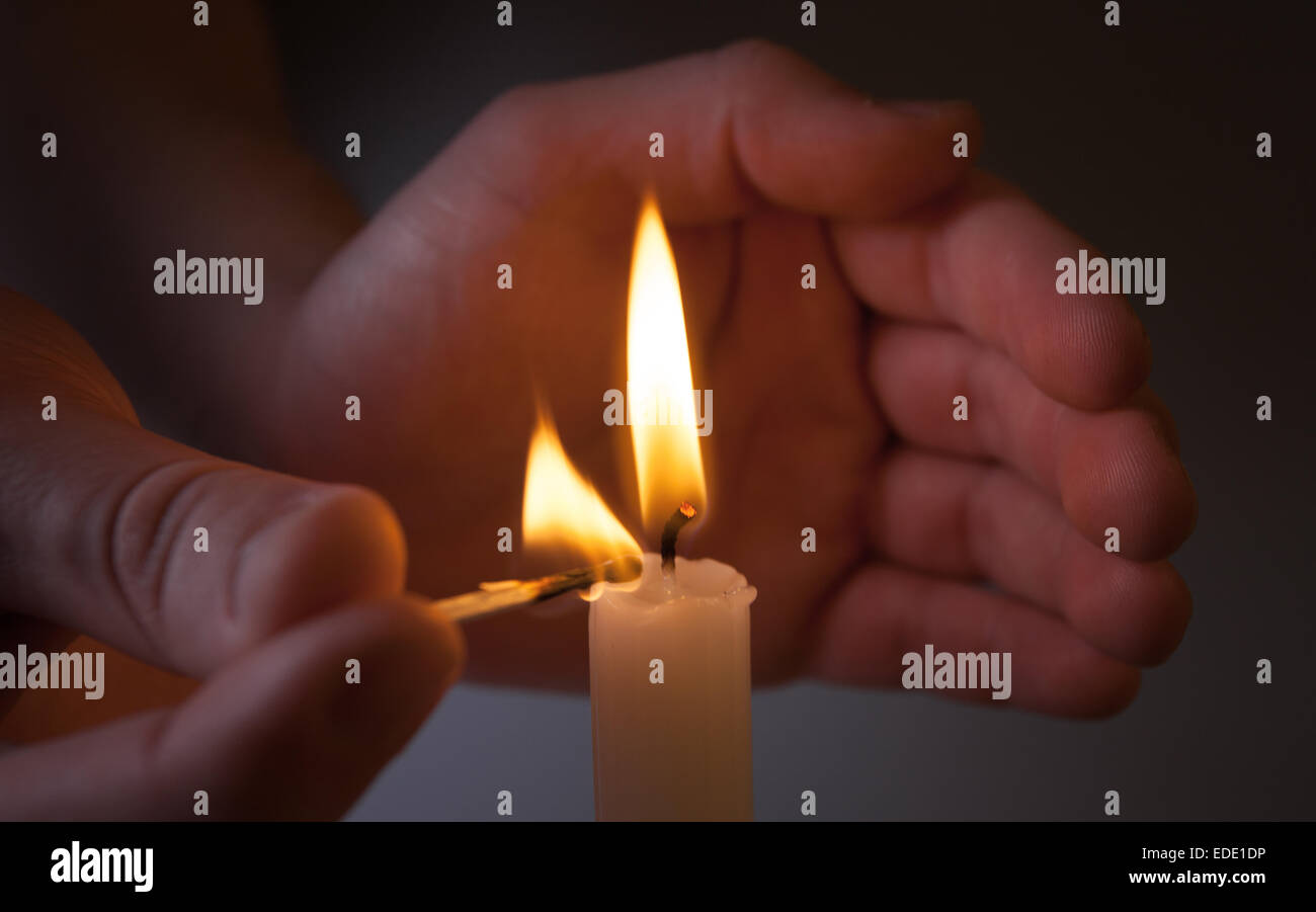 Hand holding lit match igniting hi-res stock photography and images - Alamy