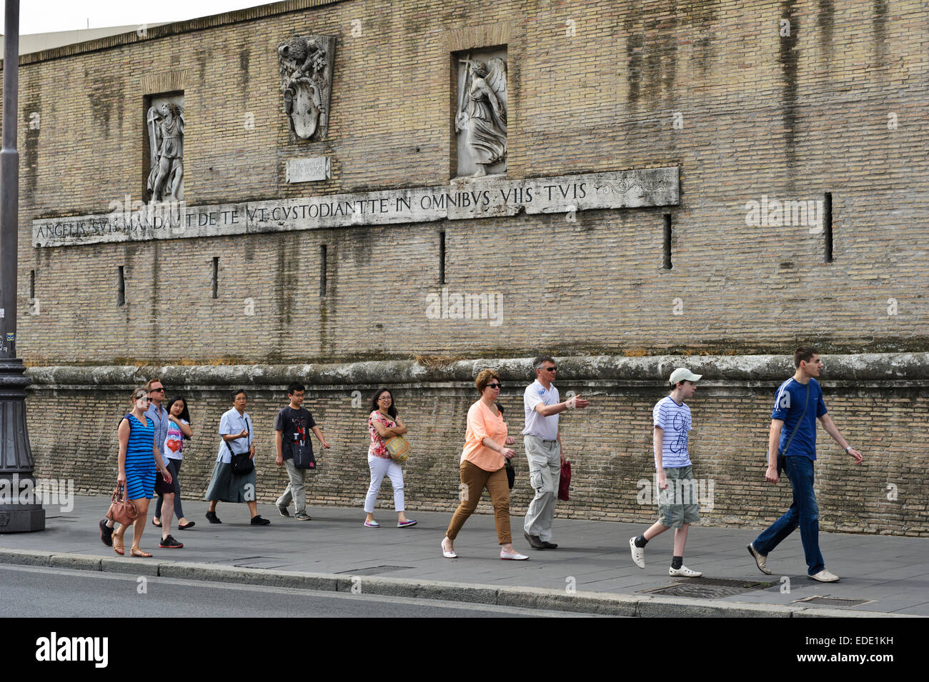 High wall with Papal emblem and two sculptures surrounding the Vatican ...