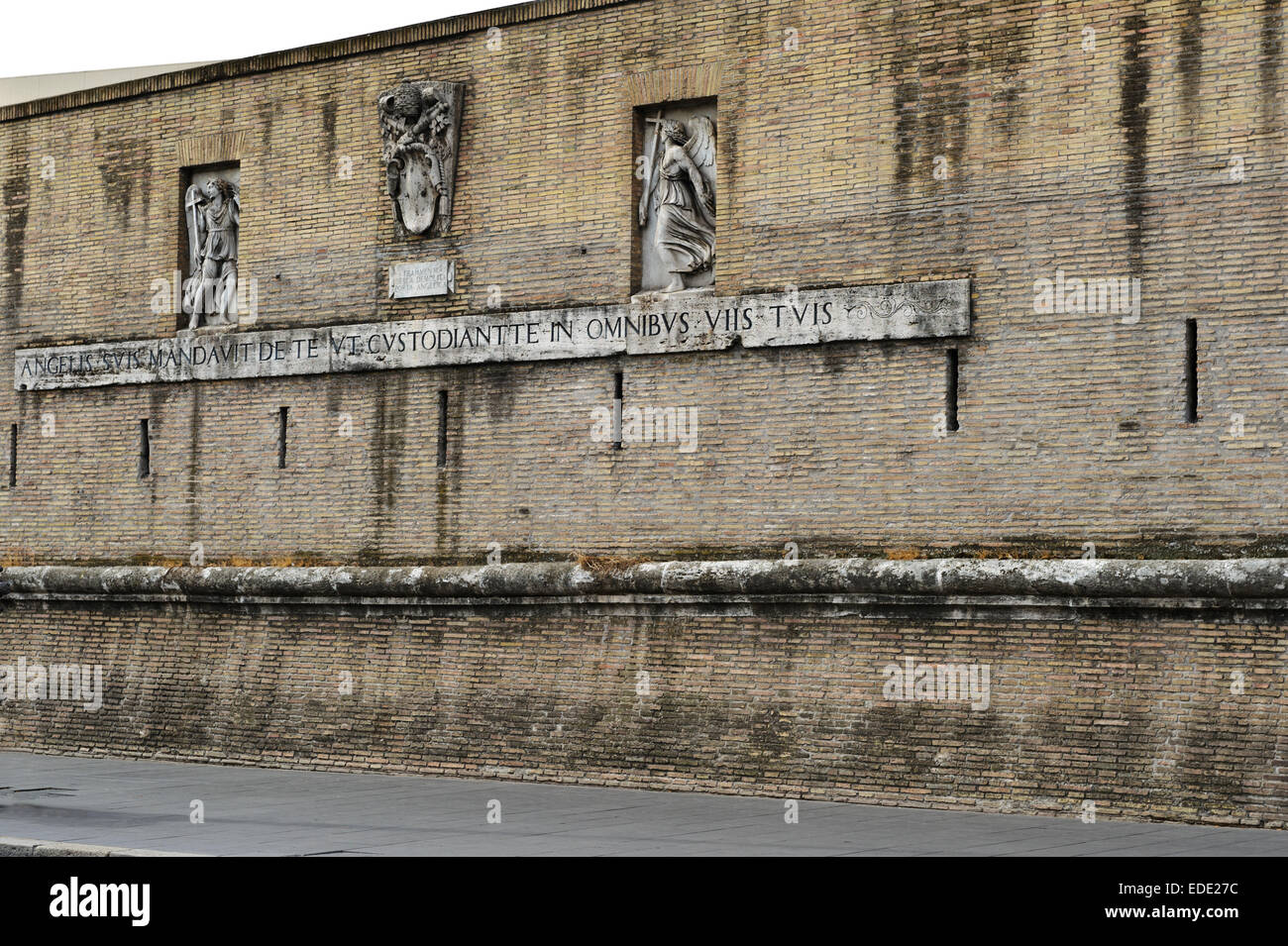 High wall with Papal emblem and two sculptures surrounding the Vatican ...