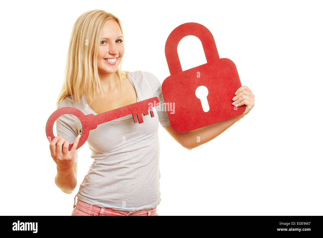 Young blond woman holding big red key and a lock Stock Photo - Alamy