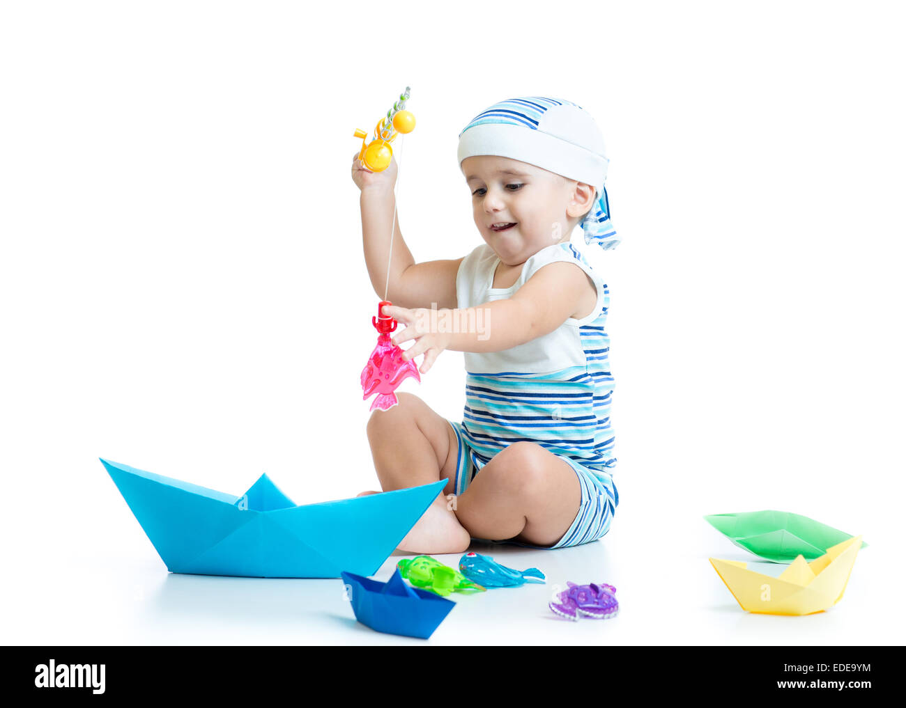 little child playing with fishing rod toy Stock Photo - Alamy