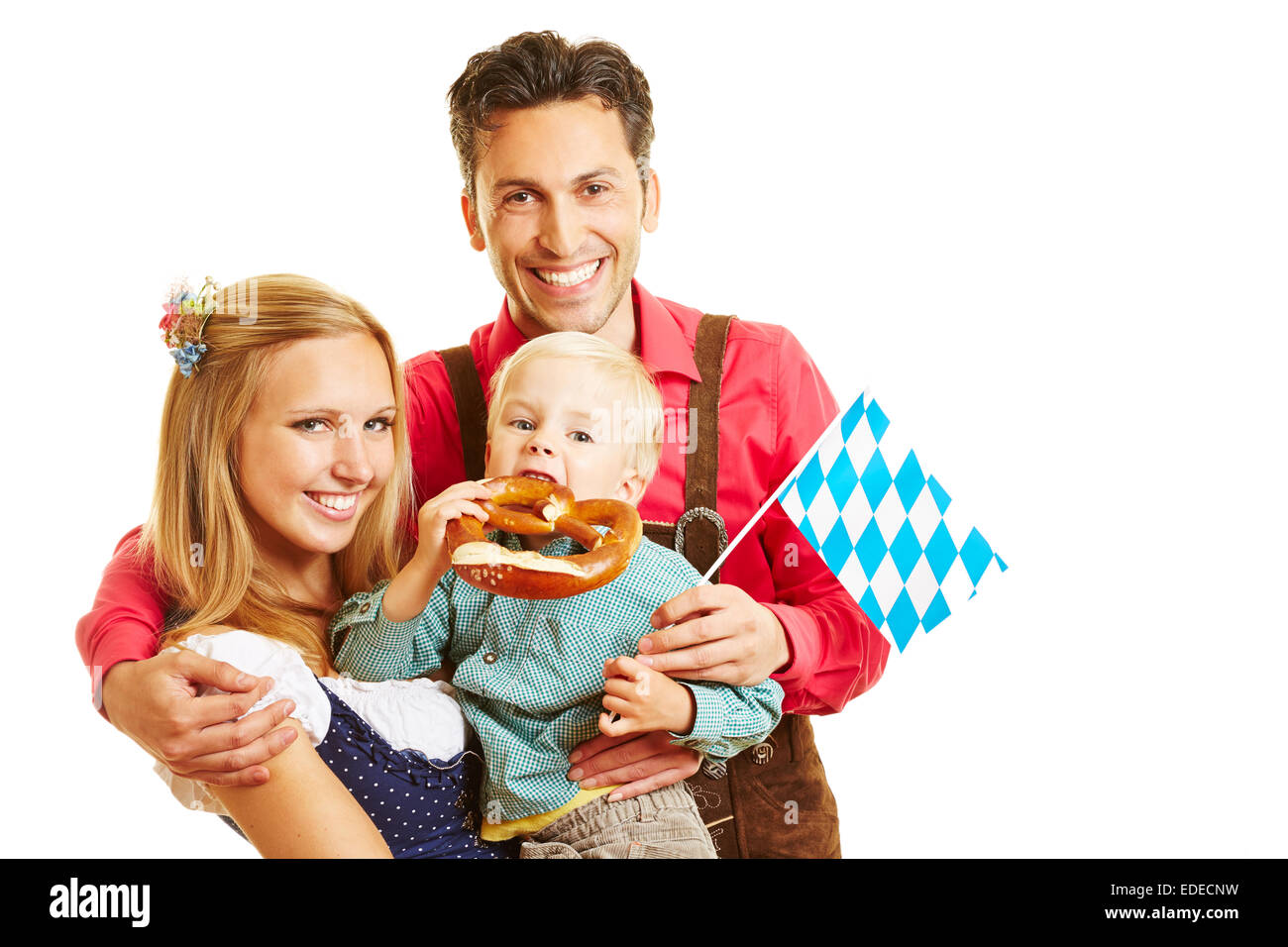 Happy bavarian family smiling with pretzel and flag Stock Photo - Alamy