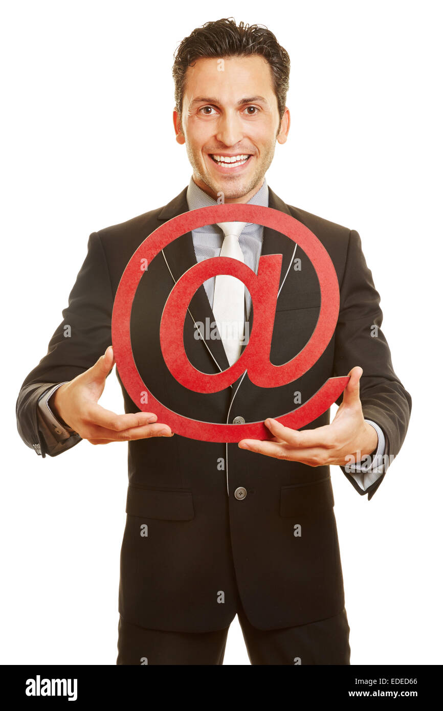 Smiling businessman holding big red at sign as internet symbol Stock ...