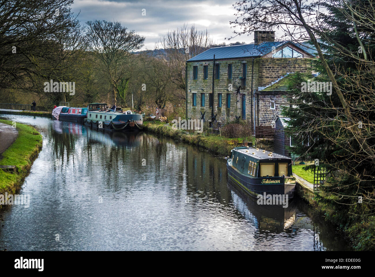 Canal side house with moored barges, Leeds Liverpool Canal, West ...