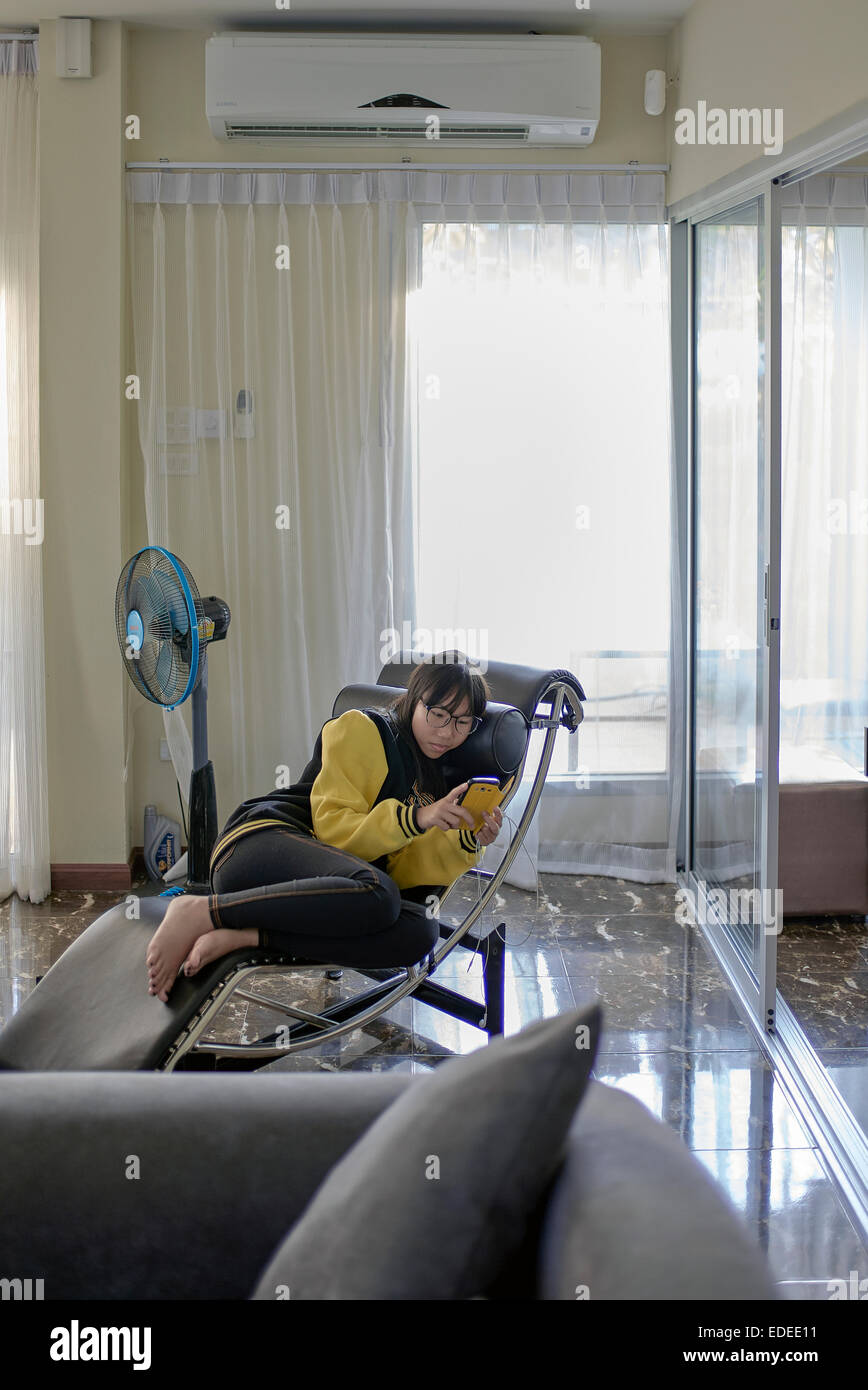 Teenage girl preoccupied with her mobile phone Stock Photo - Alamy