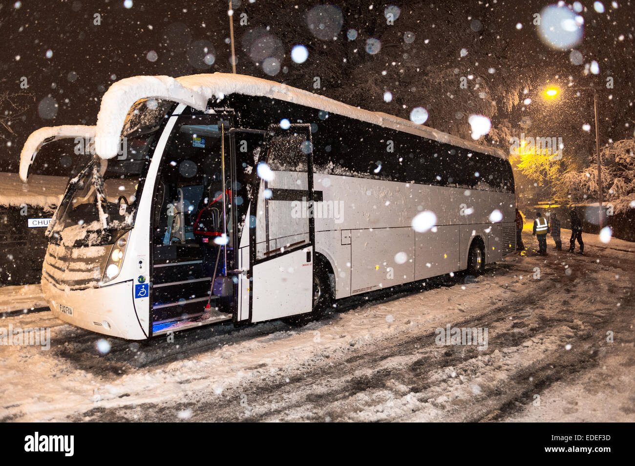 A stranded coach stuck on a hill during a snow storm in Mansfield ...