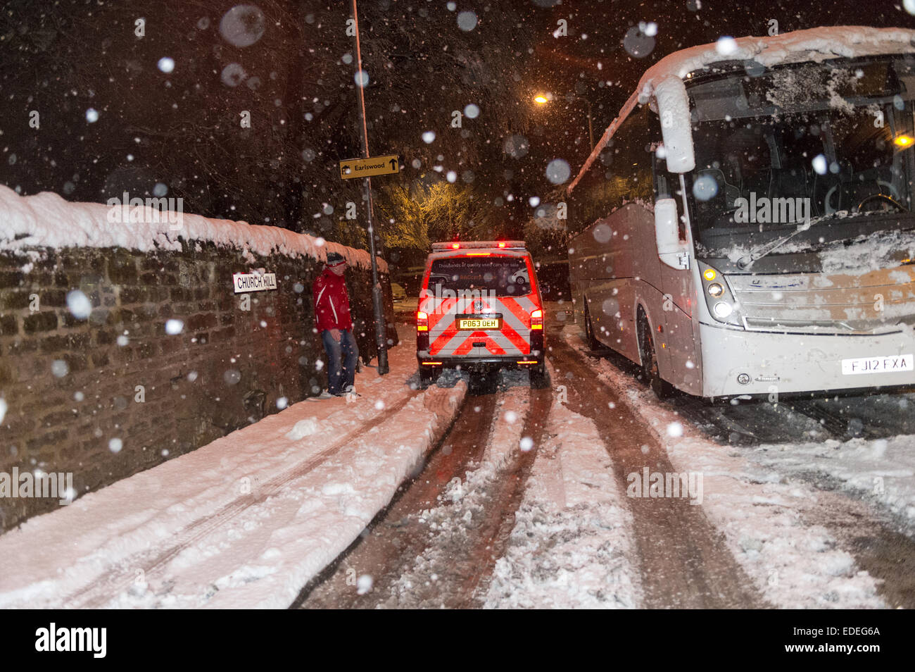 An R.A.C. breakdown vehicle passes a stranded coach due icy and snowy ...