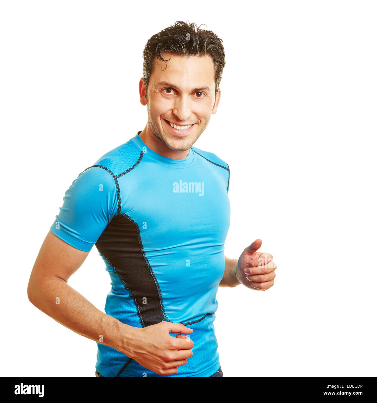 Smiling young man in sports clothing running Stock Photo - Alamy