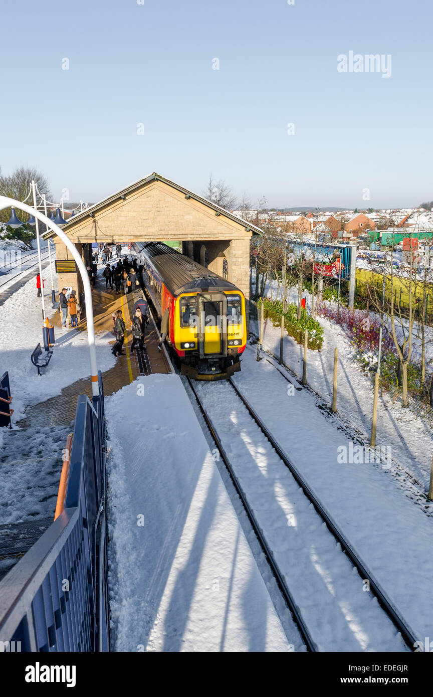 Passengers getting onto a commuter train at a local train station after ...