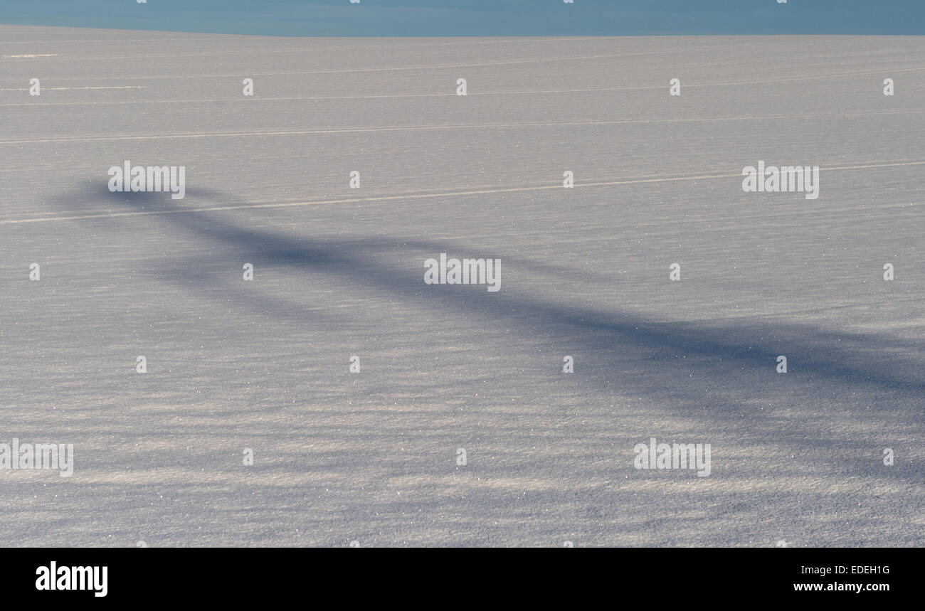 The shadow of a high voltage steel electrical distribution pylon in a ...