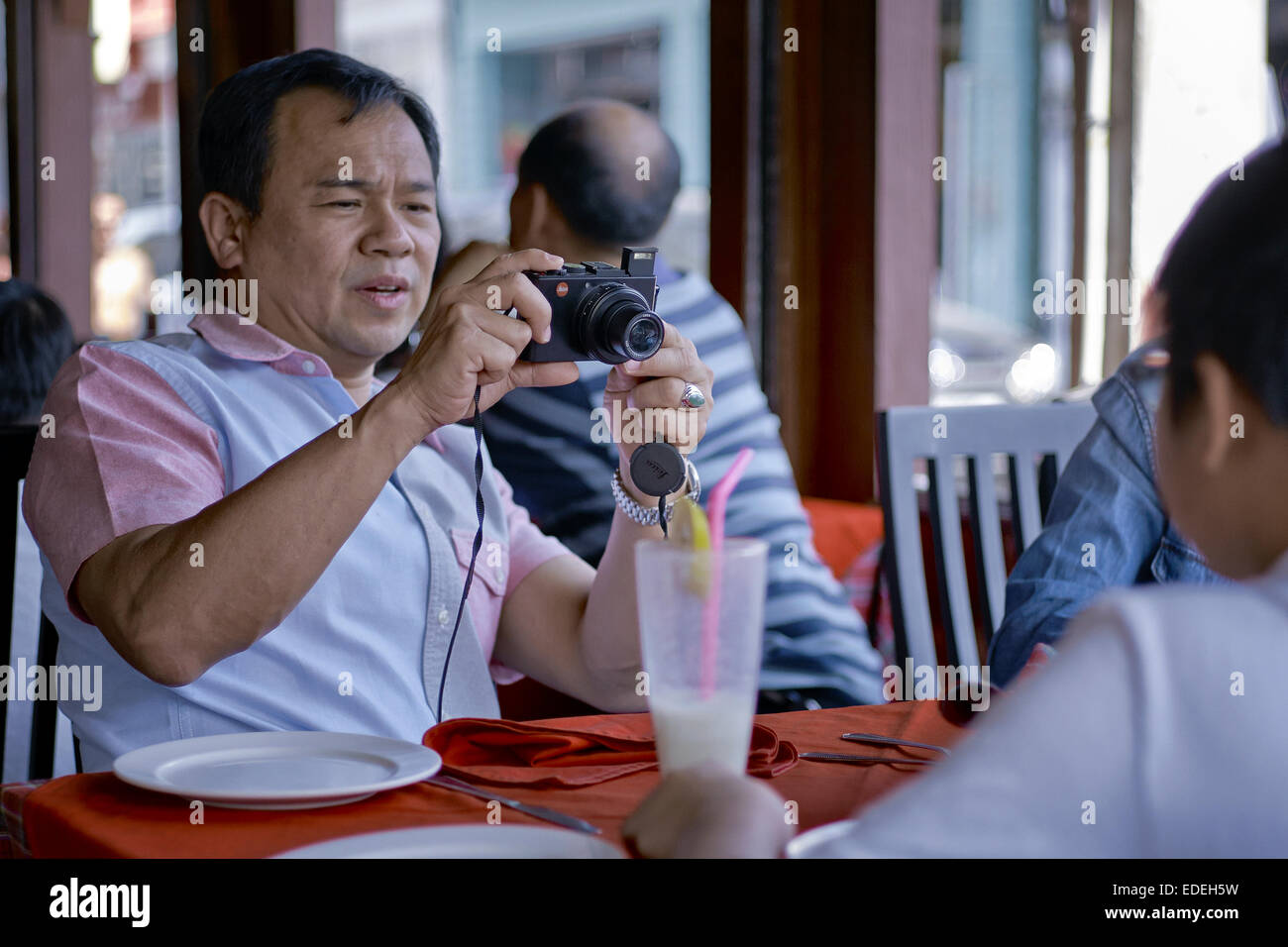 Using digital camera. Father using a Leica D-Lux 6 digital compact ...