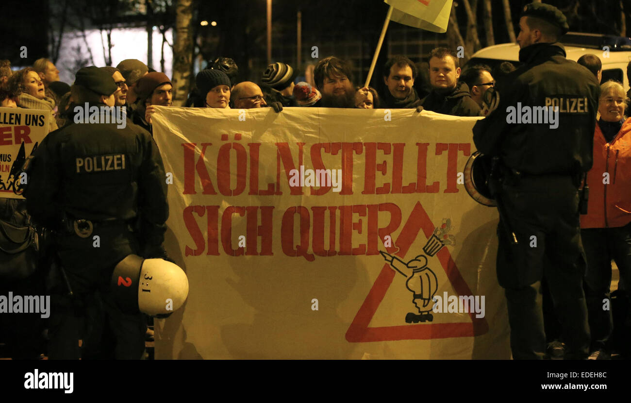 Cologne, Germany. 5th Jan, 2015. Demonstrators hold a banner in their ...