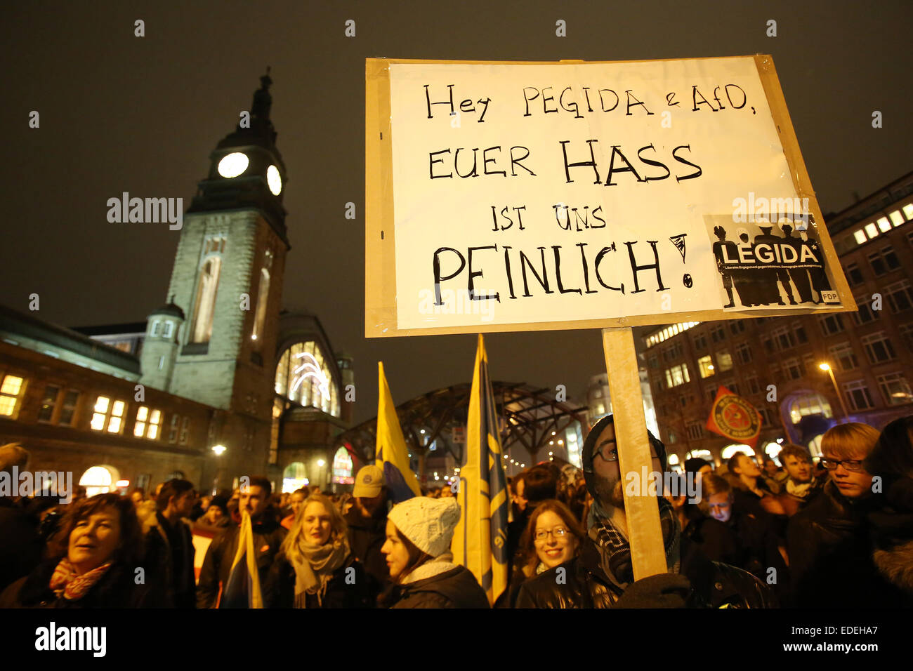 Participants hold a placard in ther hands which reads 'Hey Pegida and ...