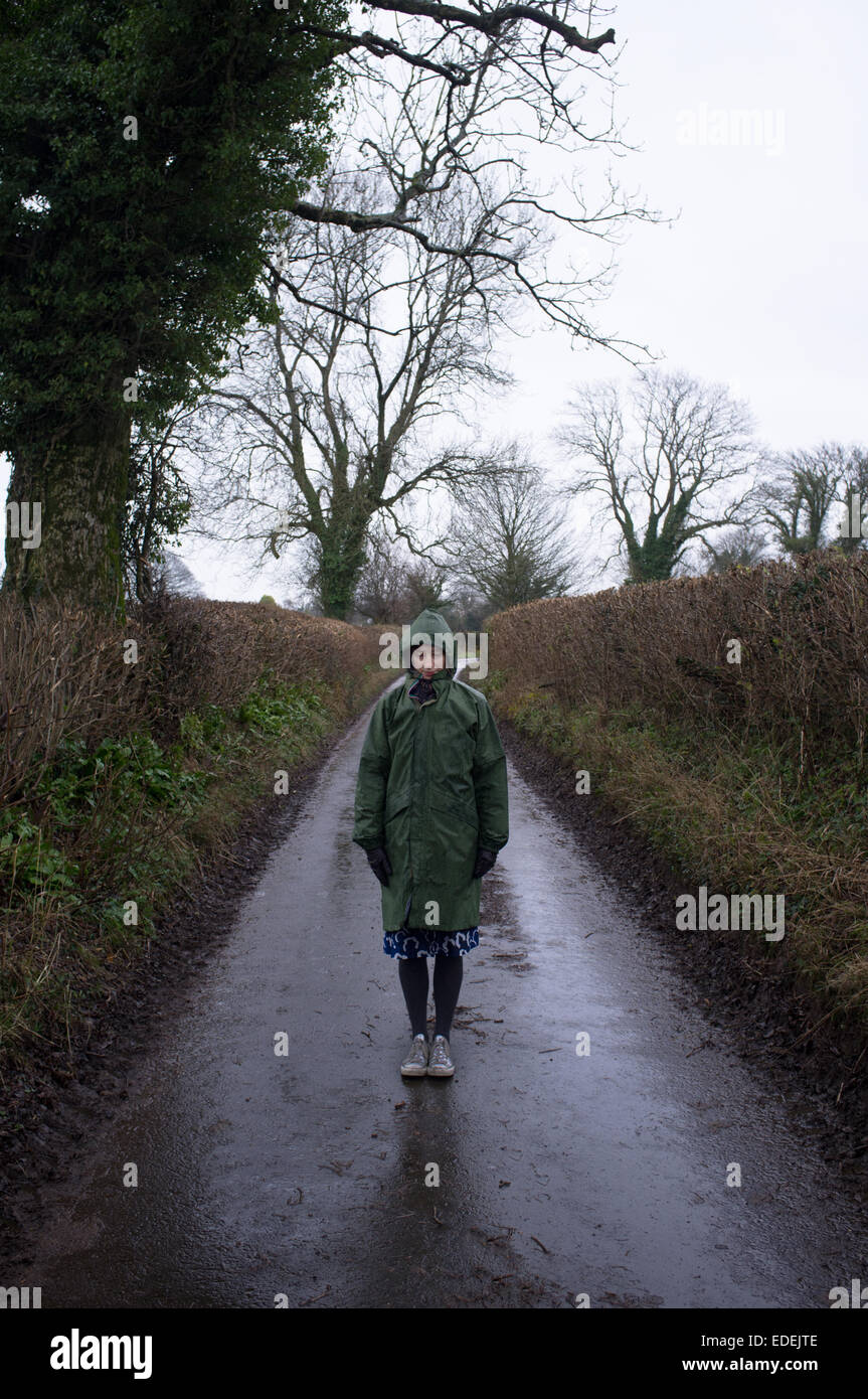 A woman stands on a country lane Stock Photo - Alamy