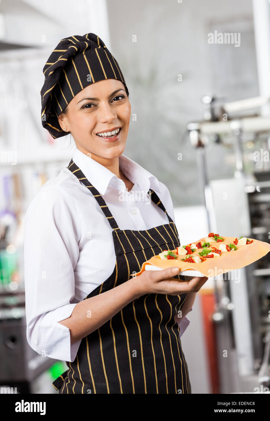 Happy Chef Holding Tray With Stuffed Pasta Sheet Stock Photo - Alamy