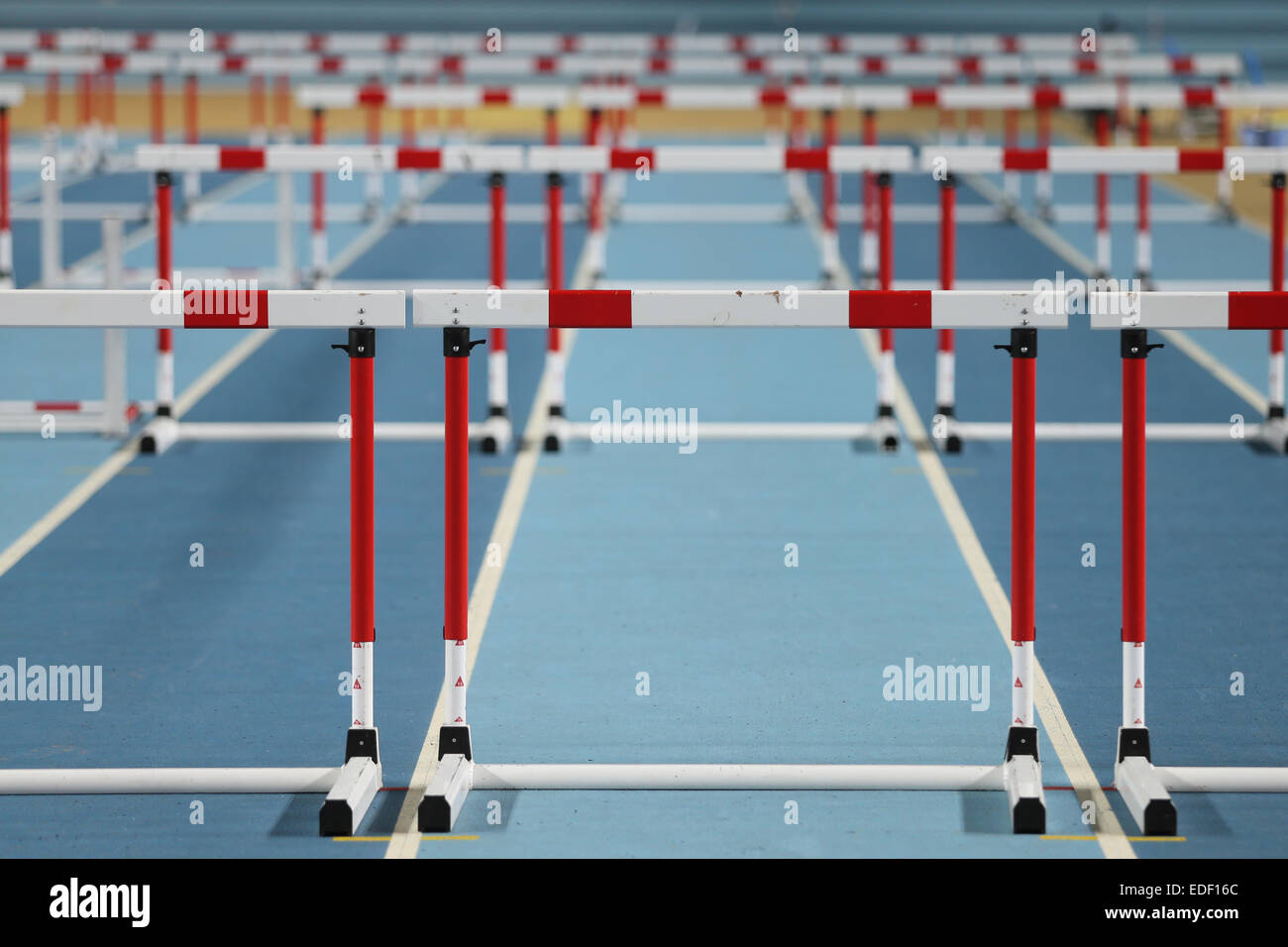Barriers over a running track in athletics hall Stock Photo - Alamy