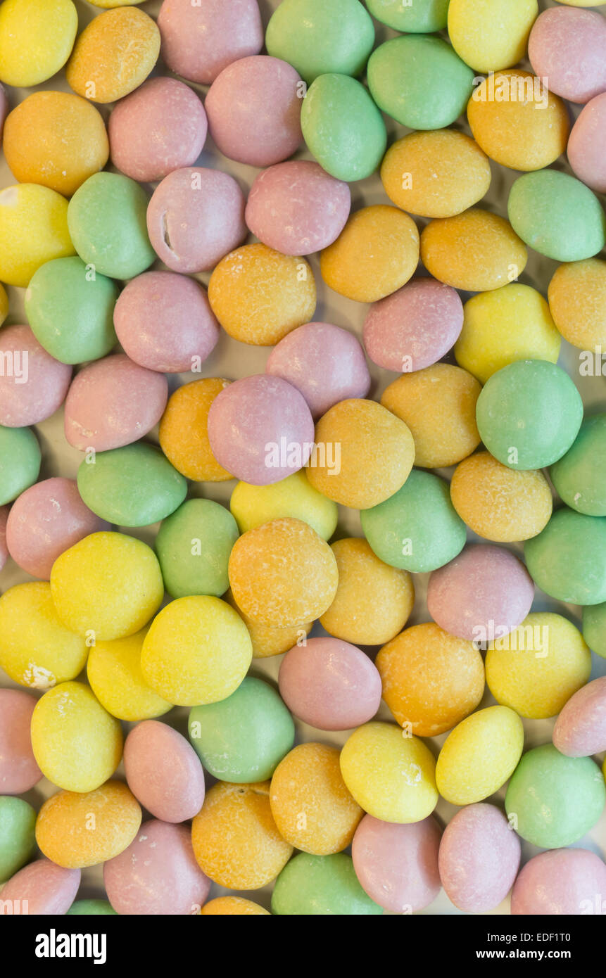 little colored sugar bonbons background close up - top view Stock Photo ...