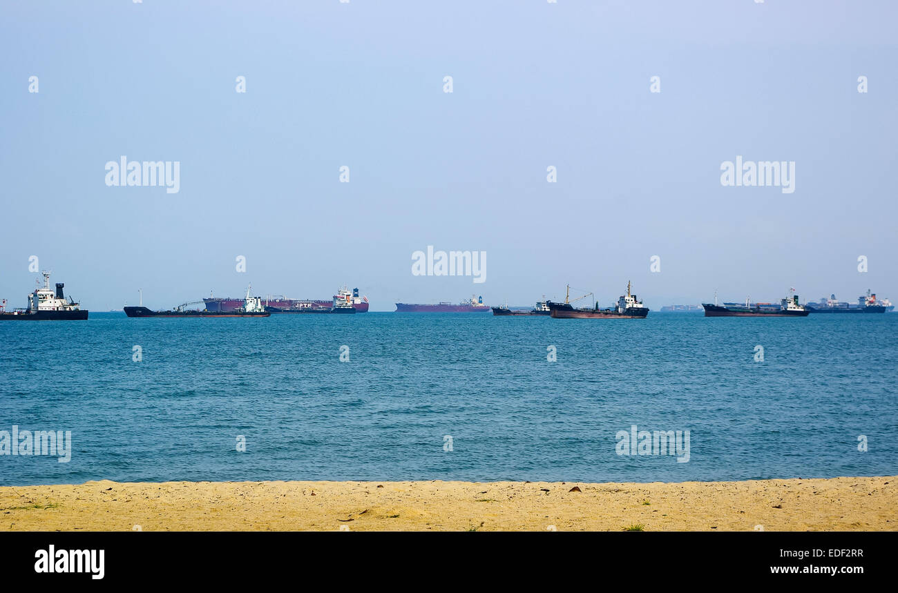 an offshore line of cargo ships in asian sea Stock Photo - Alamy