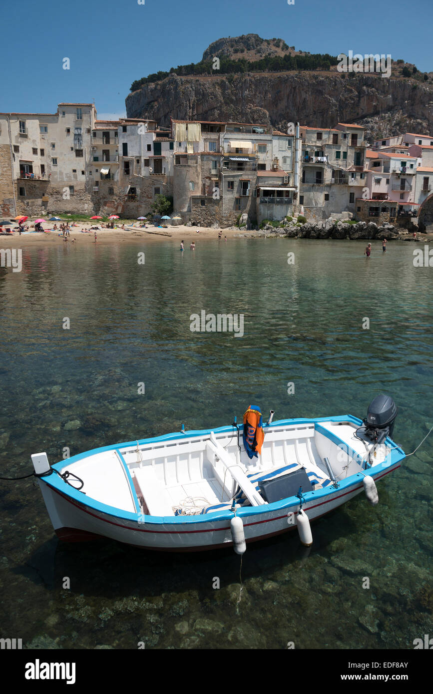 A small fishing boat moored in the old harbour at Cefalu Sicily Italy ...
