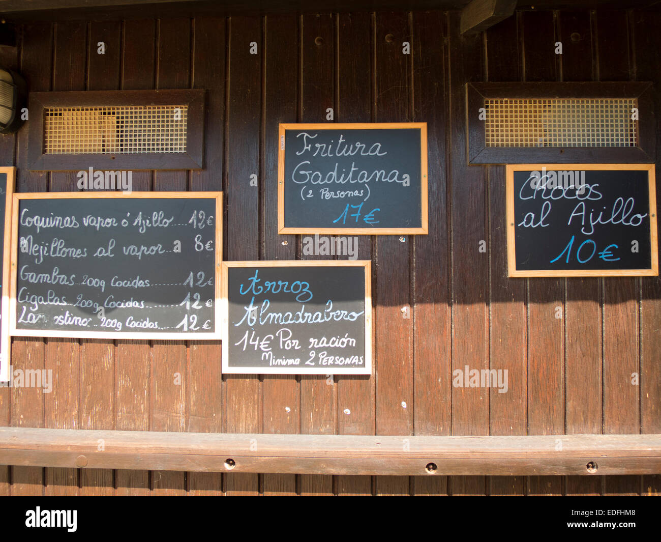 four black placards spanish handwritten in brown wood wall with typical ...