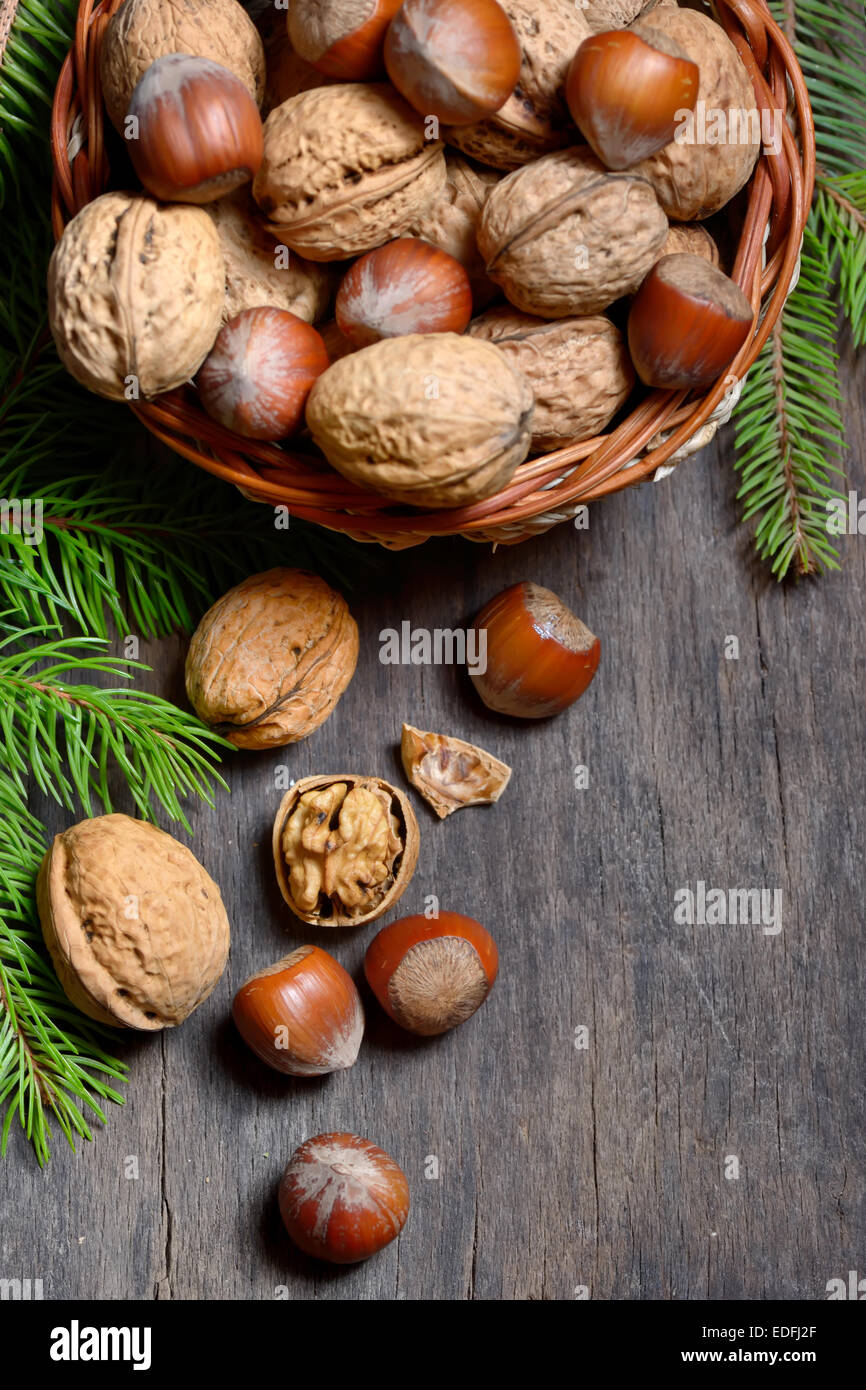 Walnuts and hazelnuts in bowl isolated on old wooden background Stock ...