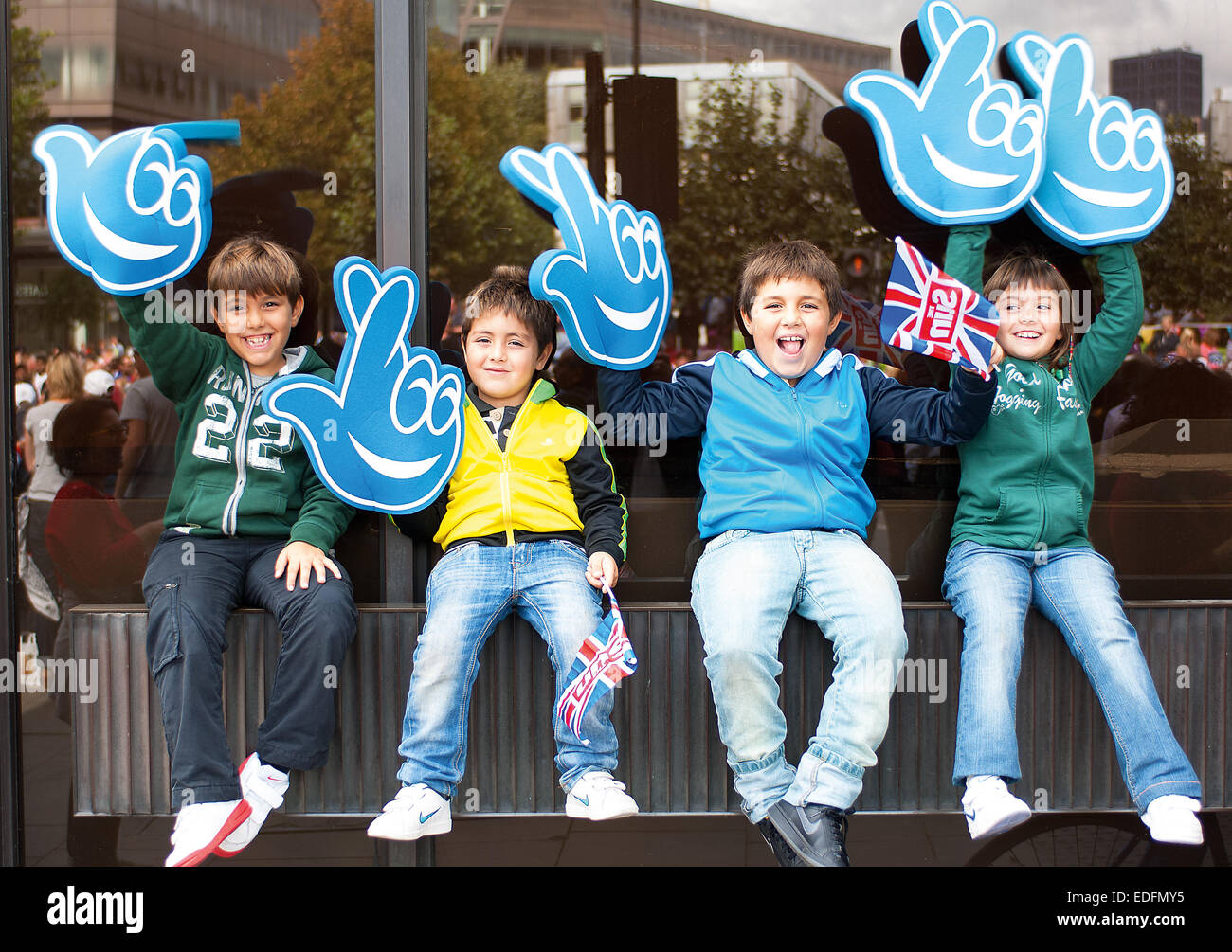 A group of children wave the giant hands which were such a symbol of ...