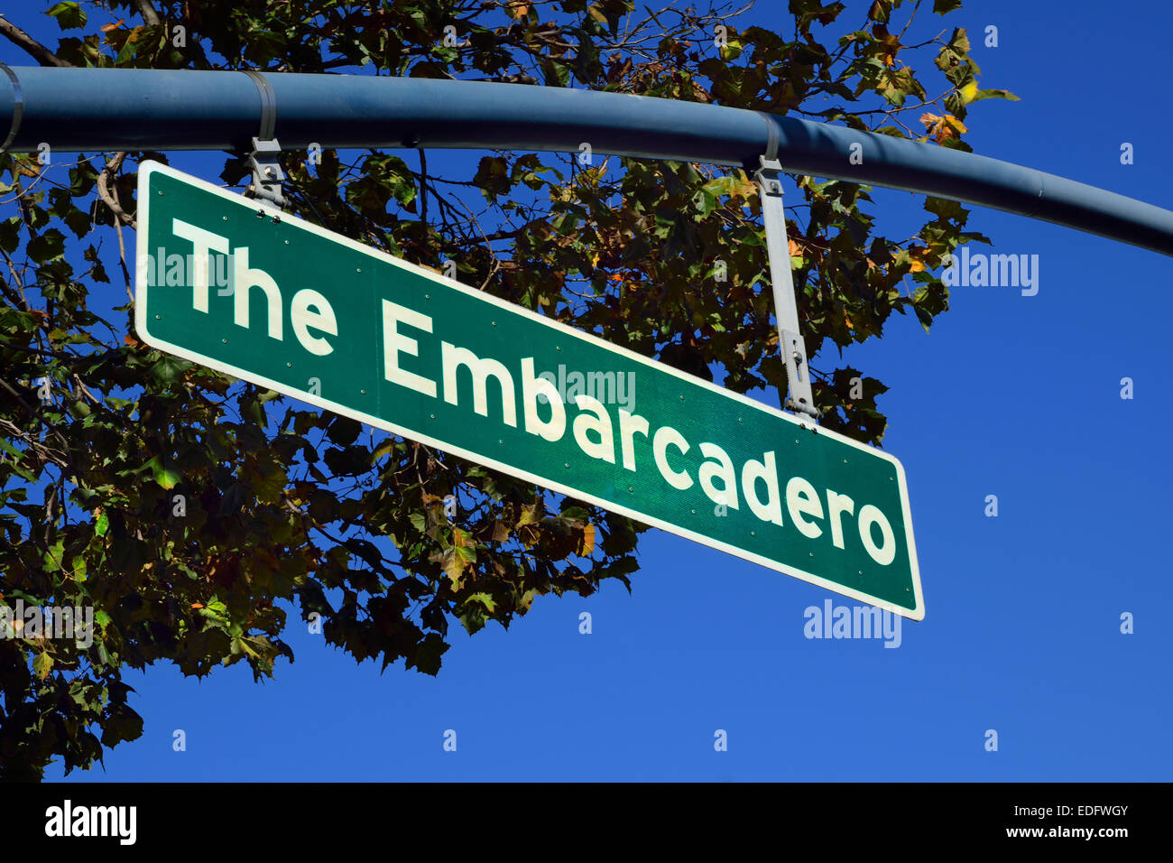 Sunlit road sign for the Embarcadero a waterfront road and walkway ...