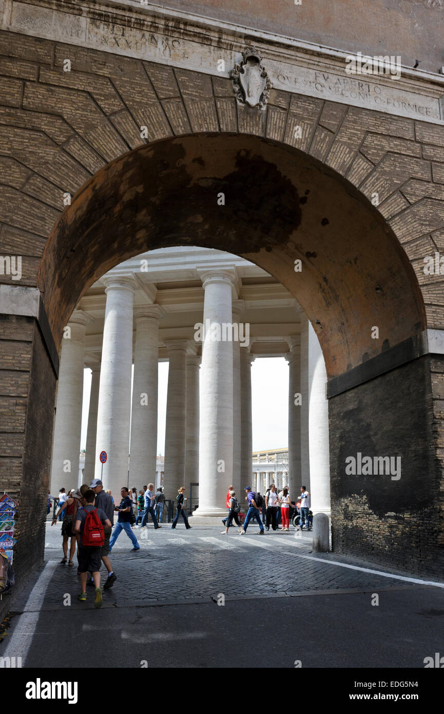 Tourists walking along a cobbled pathway lined with giant columns in St ...