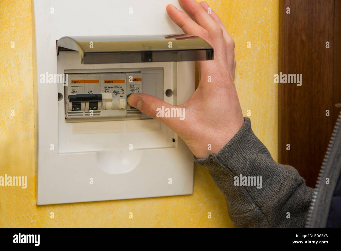 Close up of male hand using an electronic control panel, to switch on ...