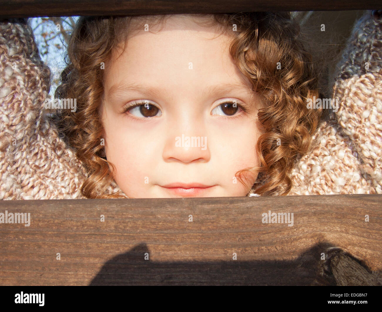 Baby Peeking Over Fence