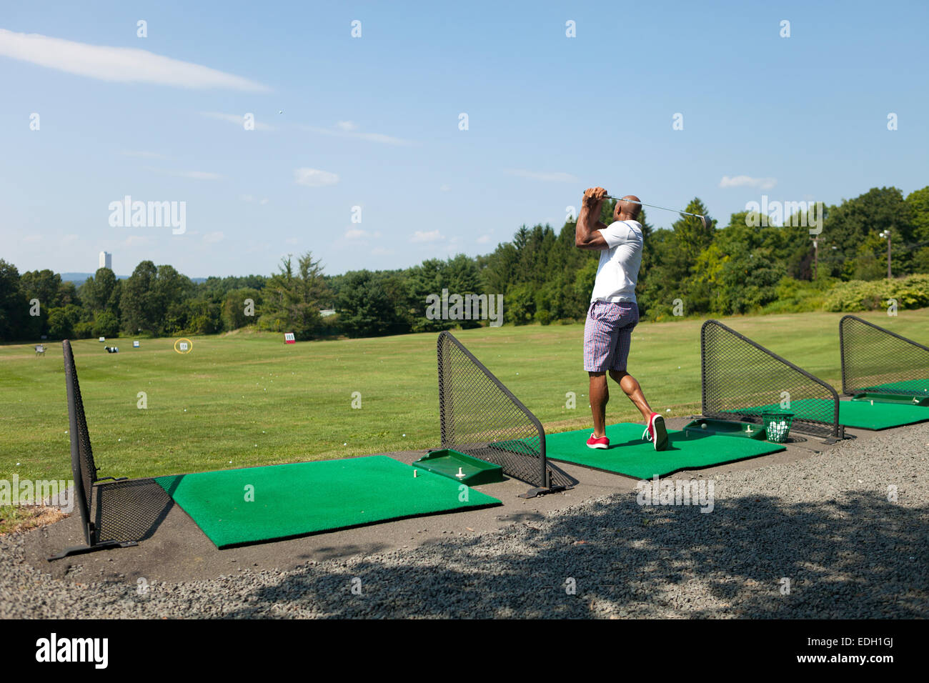 Golfing at the Range Stock Photo - Alamy