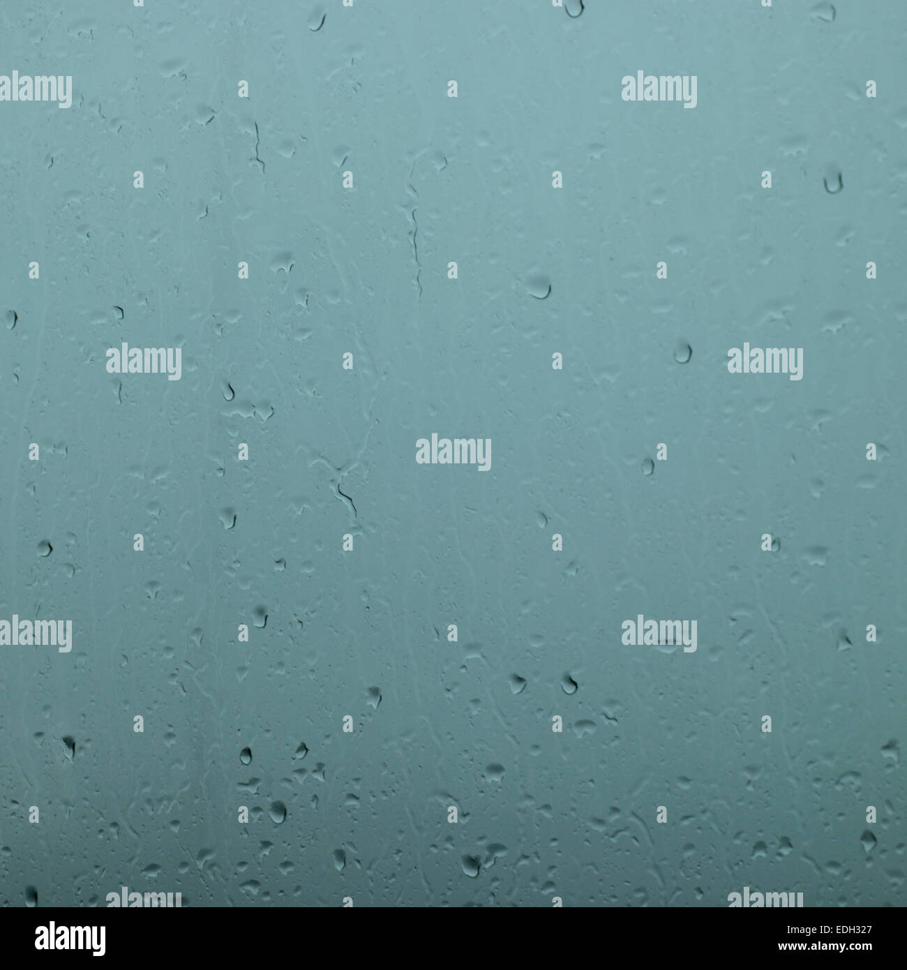 Raindrops falling down window glass hi-res stock photography and images ...