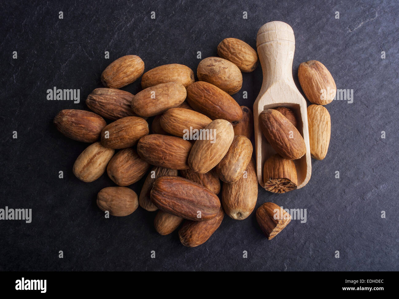 A bunch of nutmeg on black stone background Stock Photo - Alamy