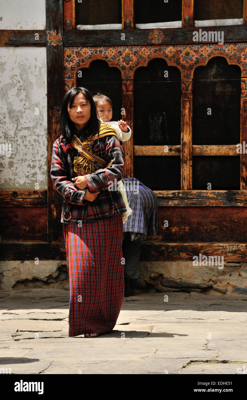 Woman carrying a child, Tamshing Goemba, Jakar, Bumthang, Bhutan Stock ...
