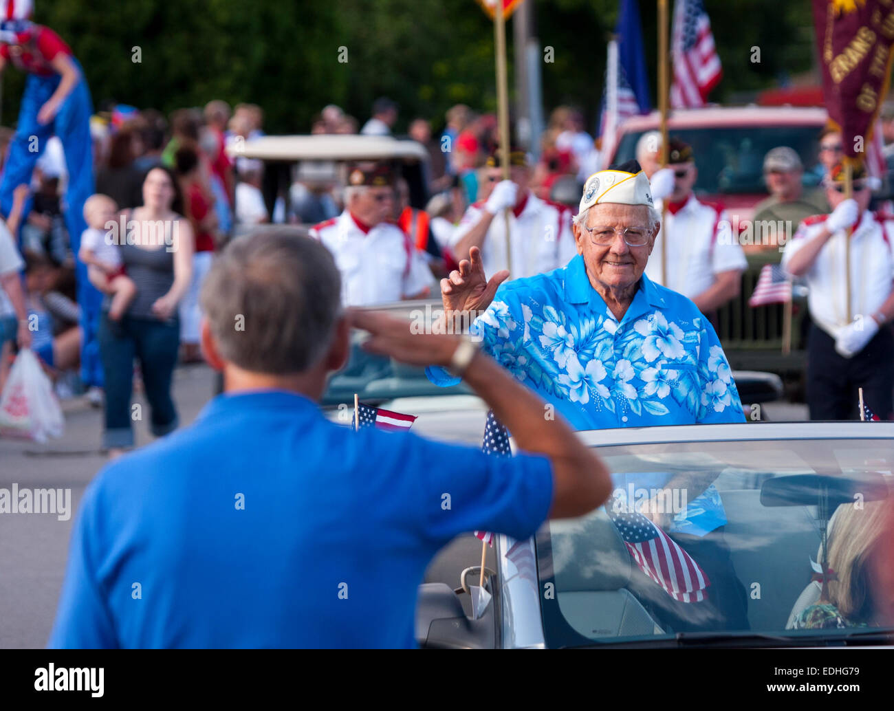 A man saluting a Pearl Harbor Survivor from WWII in a Fourth of July ...